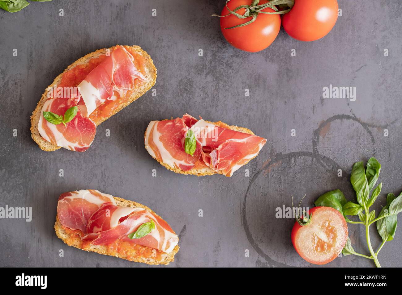 Jamon, cured ham with tomato, classic snack or tapa Spanish cuisine ...