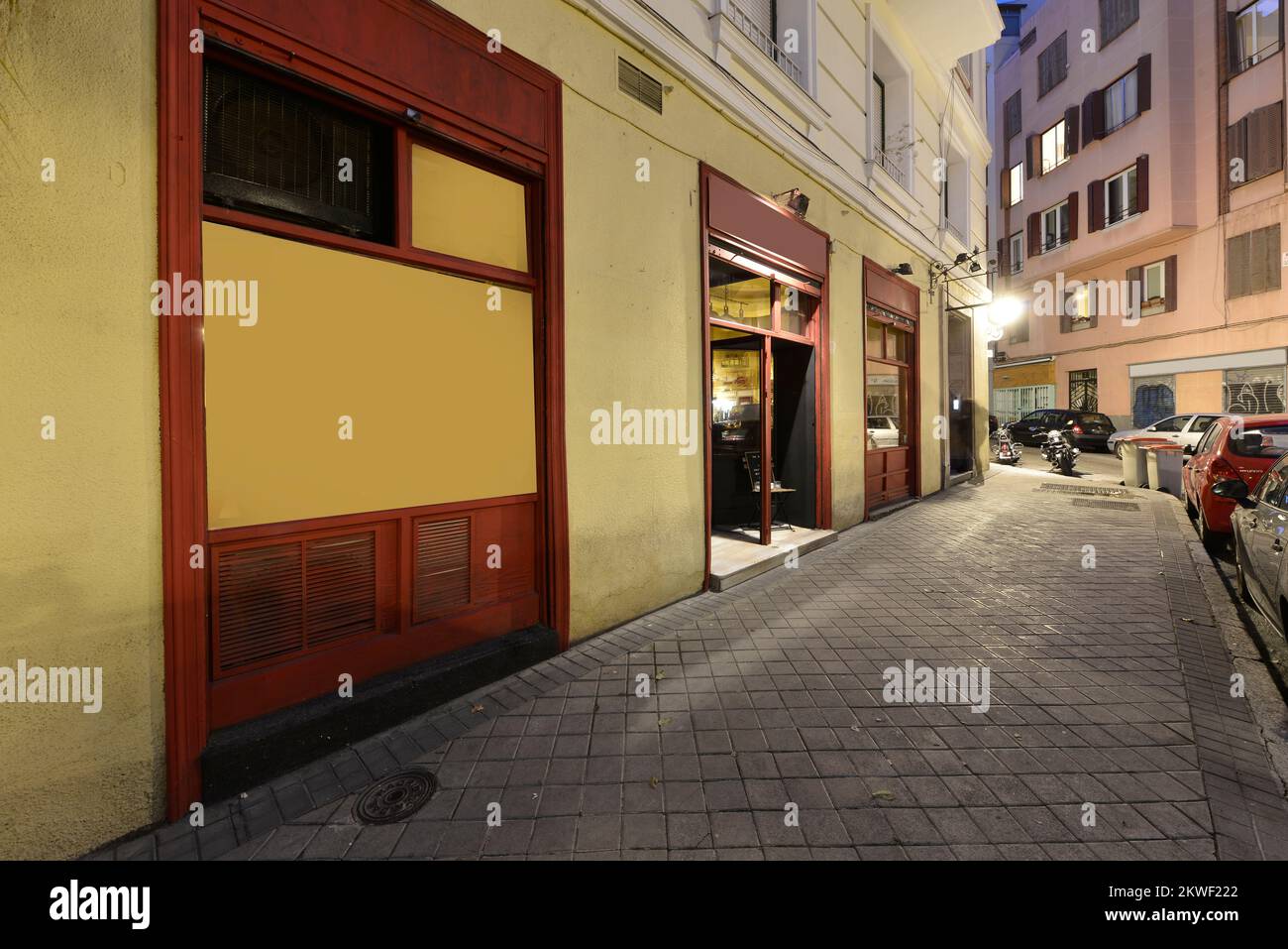 Facade of a local bar with a yellow facade and metal windows painted in ...