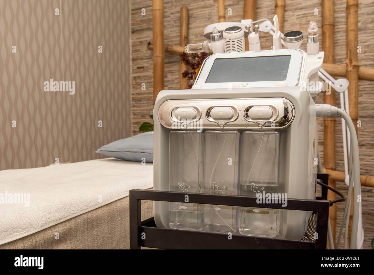 A machine to apply beauty treatments in a cabin with a stretcher and ...