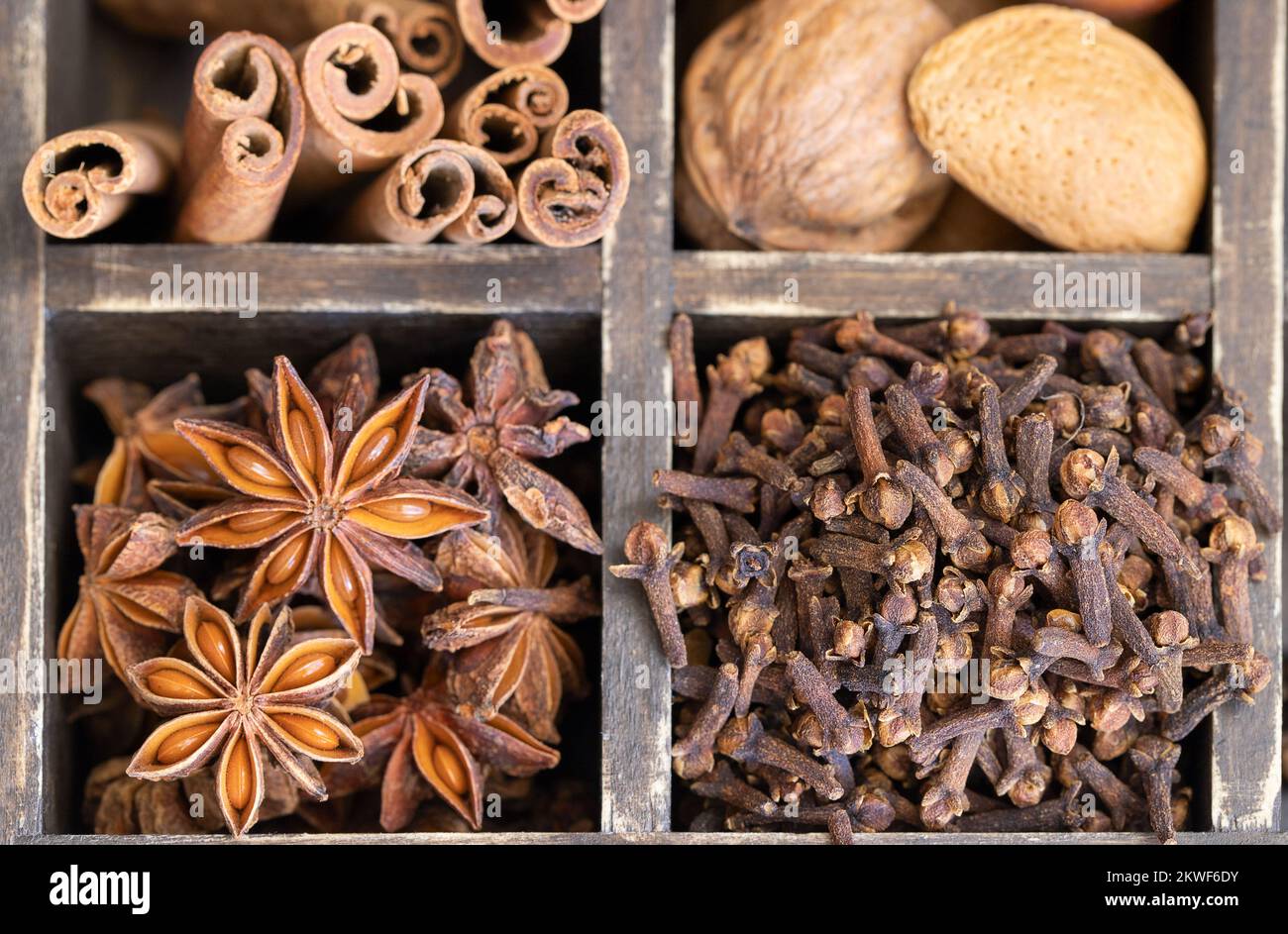 Different spices cinnamon, cloves, star anise on wooden box and nutmeg ...