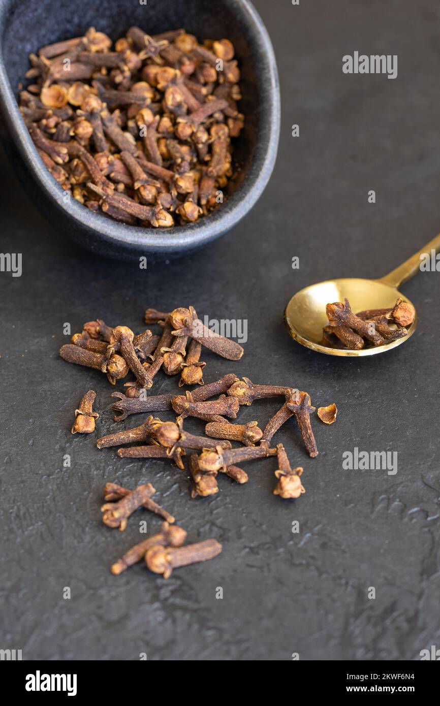 Natural clove spice on dark concrete background Stock Photo - Alamy