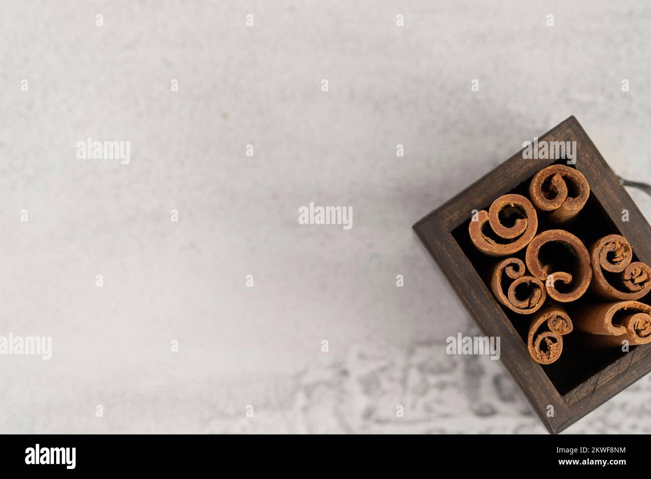 Natural Cinnamon stick in wood box on white background with copy space ...
