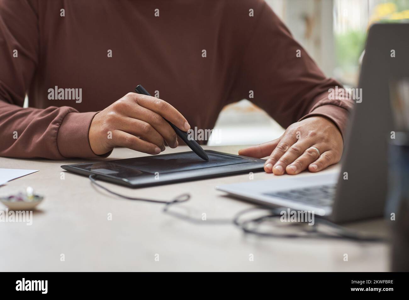 Close up of unrecognizable female artist using graphic tablet and ...