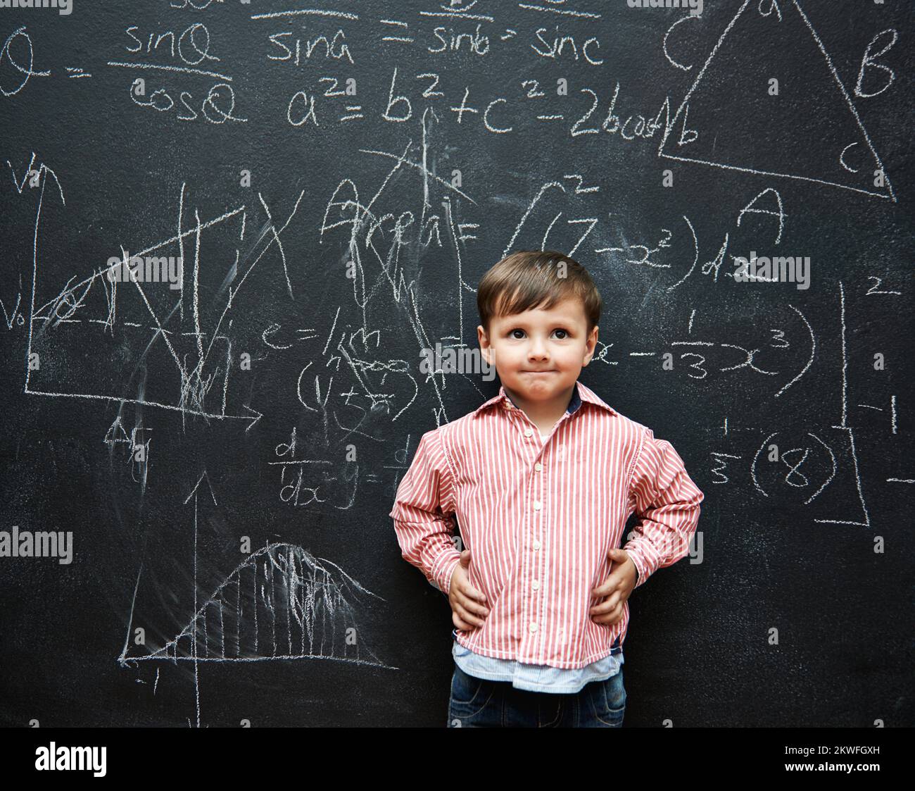My work here is done. a young boy with a blackboard full of math ...
