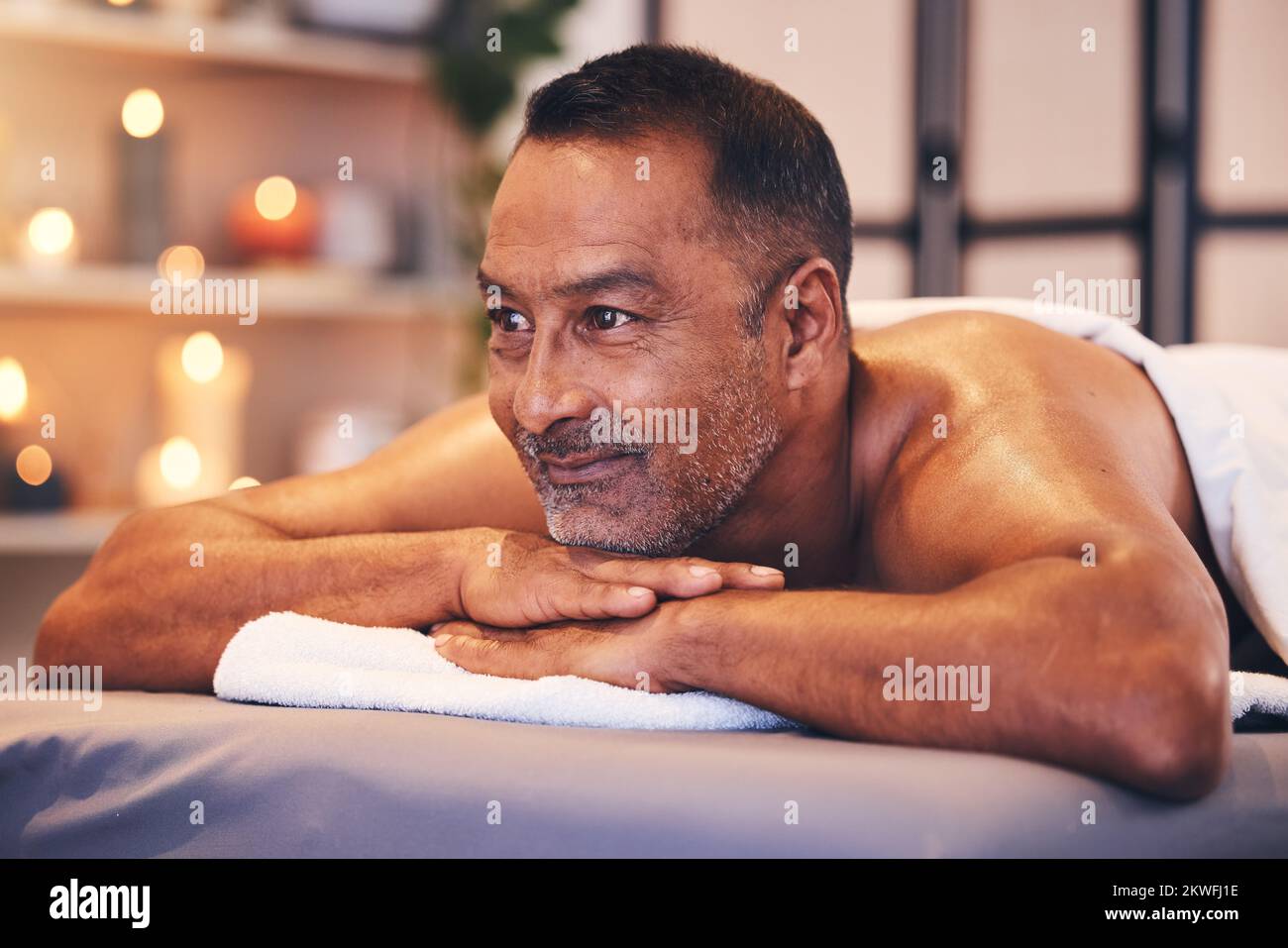 Man, spa massage and table to relax for zen, calm and physical therapy ...