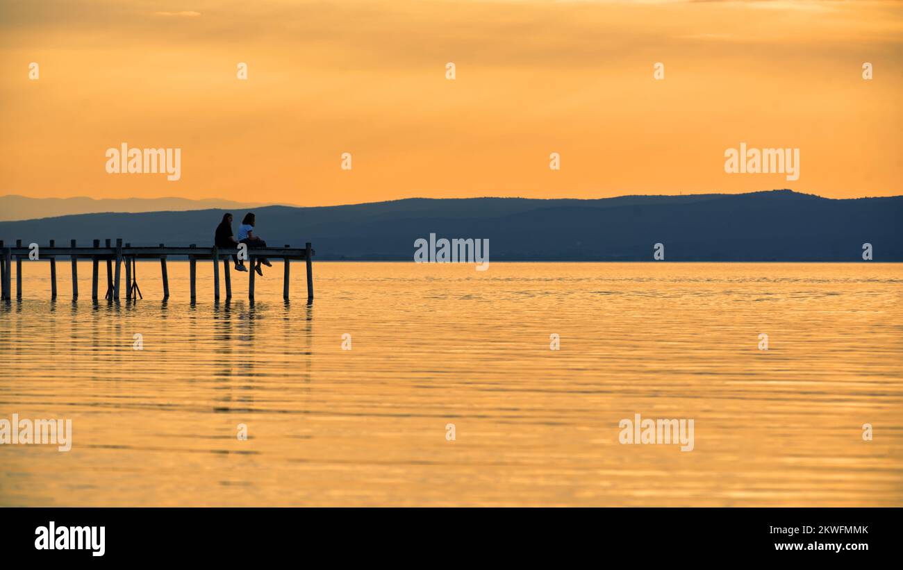 relaxing on pier, lake Stock Photo - Alamy