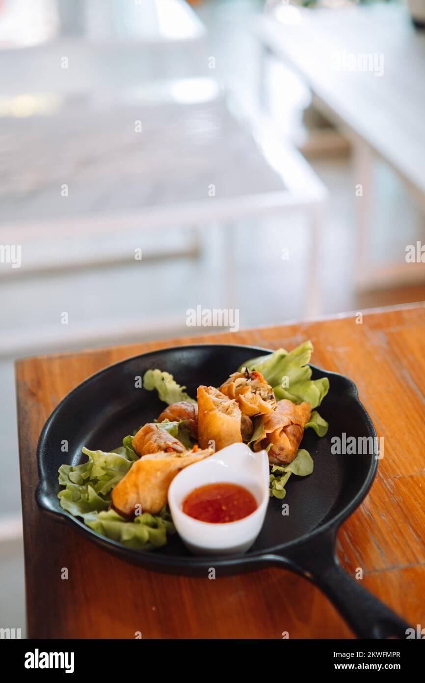 Beautiful thai food on a plate. Spring rolls with spicy sause, chicken ...