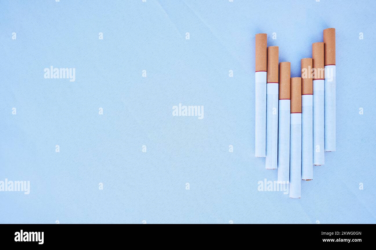 Cigarettes in a studio against a blue background mockup for cancer ...