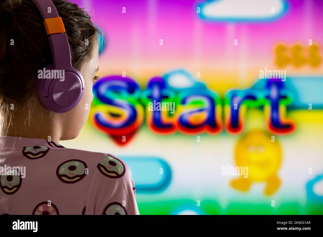 A child or teenager is playing computer video games on a large screen ...