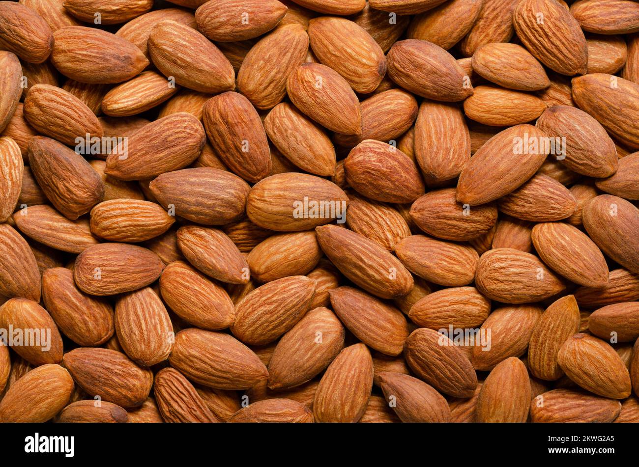 Shelled almonds, background from above. Raw, edible and whole dried ...