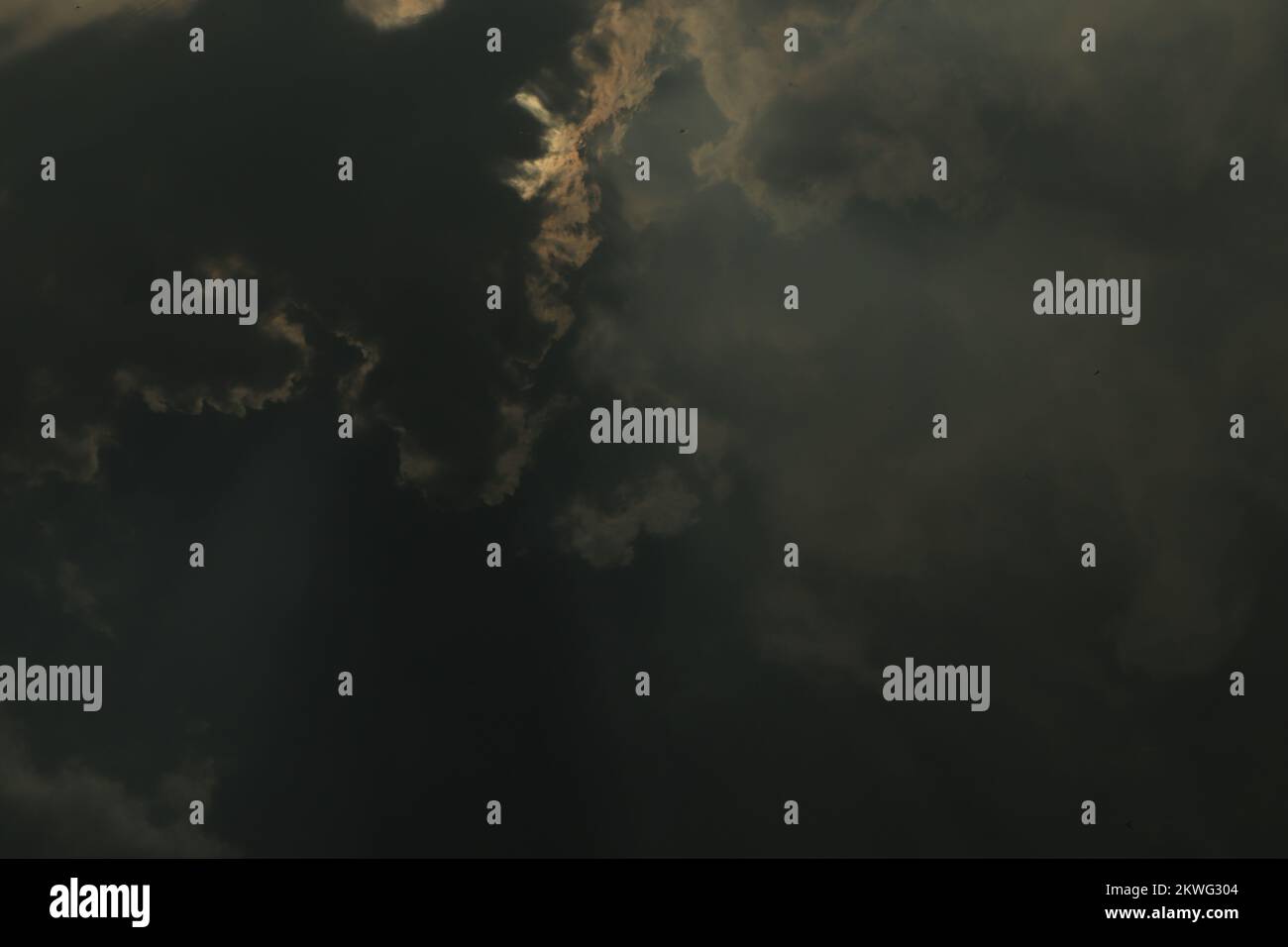 Rays of light shining through dark clouds for background Stock Photo ...