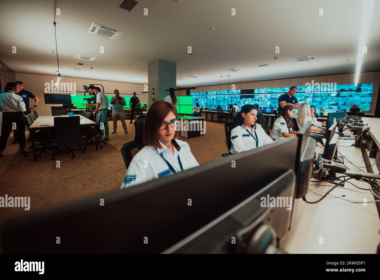 Group of female security operators working in a data system control ...