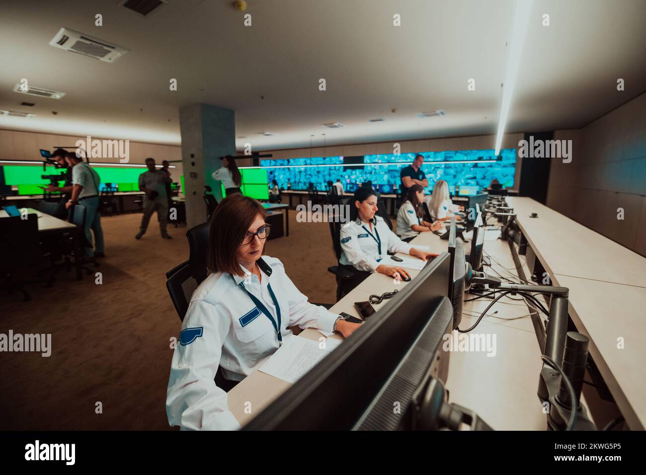 Group of female security operators working in a data system control ...