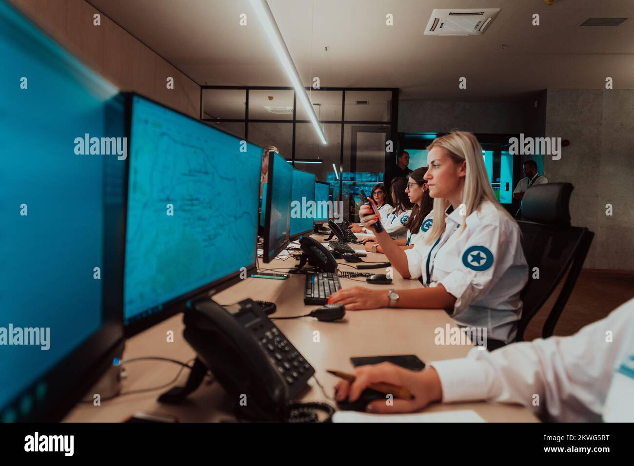 Group Of Female Security Operators Working In A Data System Control Room Technical Operators
