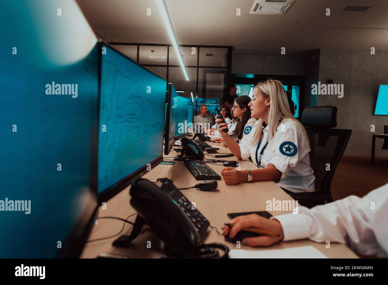 Group of female security operators working in a data system control ...