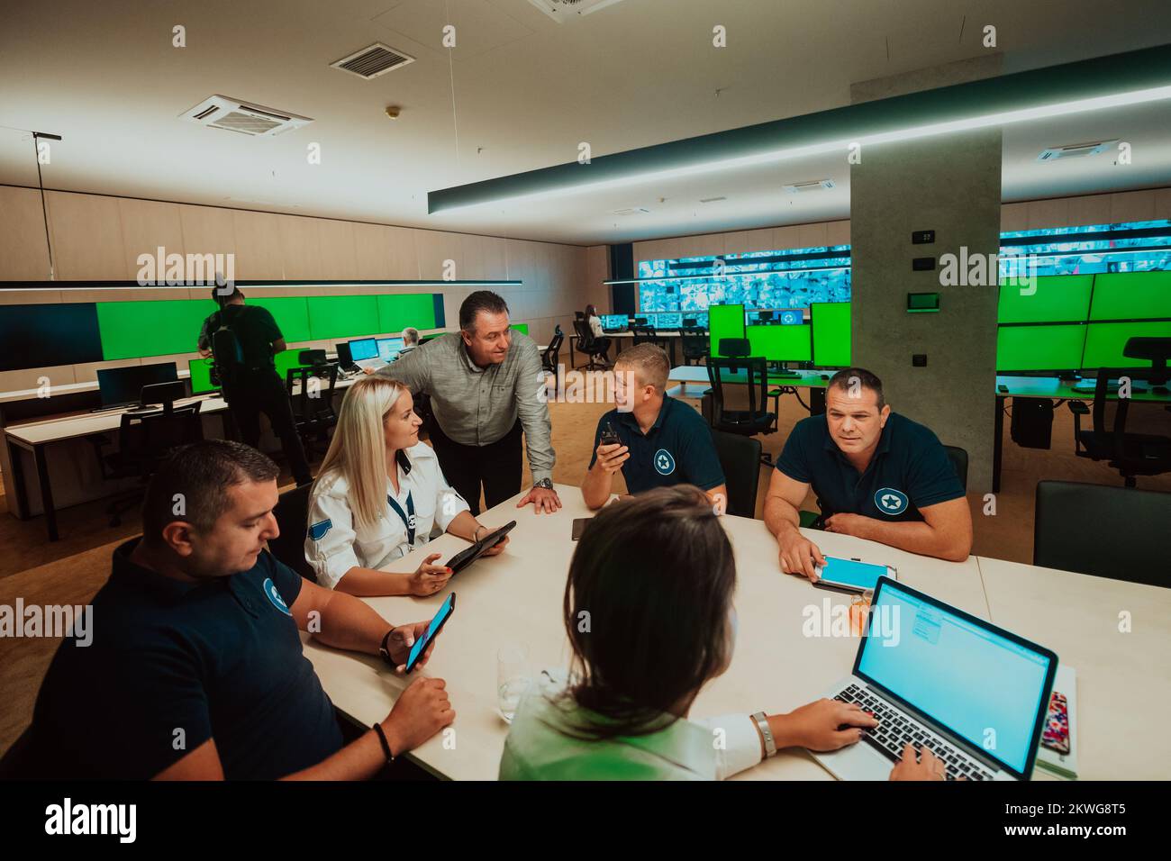 Group of security guards sitting and having briefing In the system ...