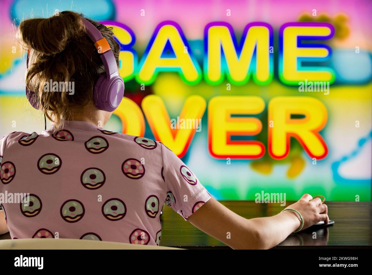 A child or teenager is playing computer video games on a large screen ...