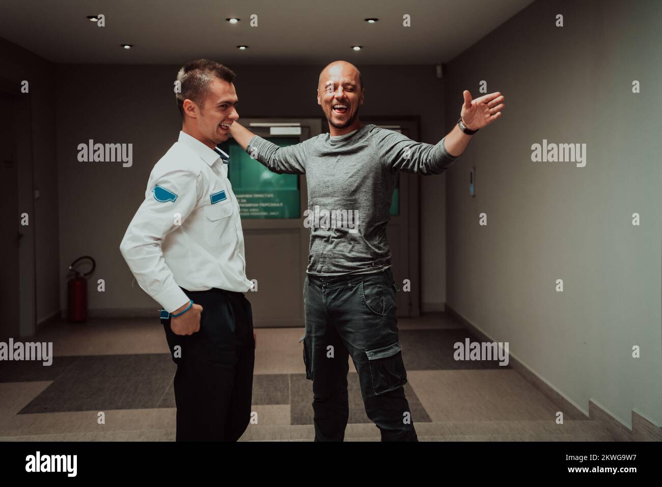 Security guard making body searching procedure on man for finding ...