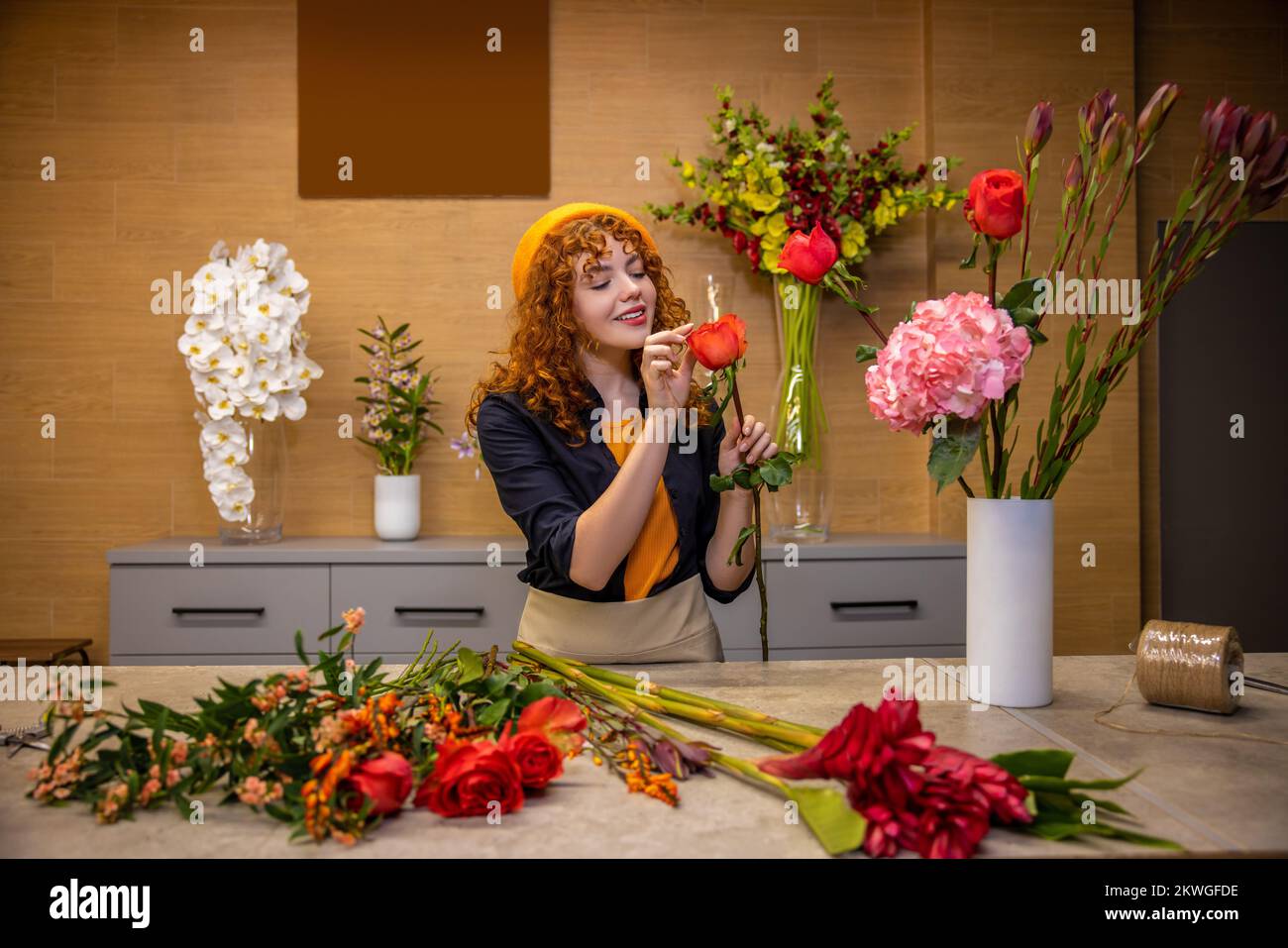 Ginger long-haired girl with flowers looking romantic Stock Photo - Alamy