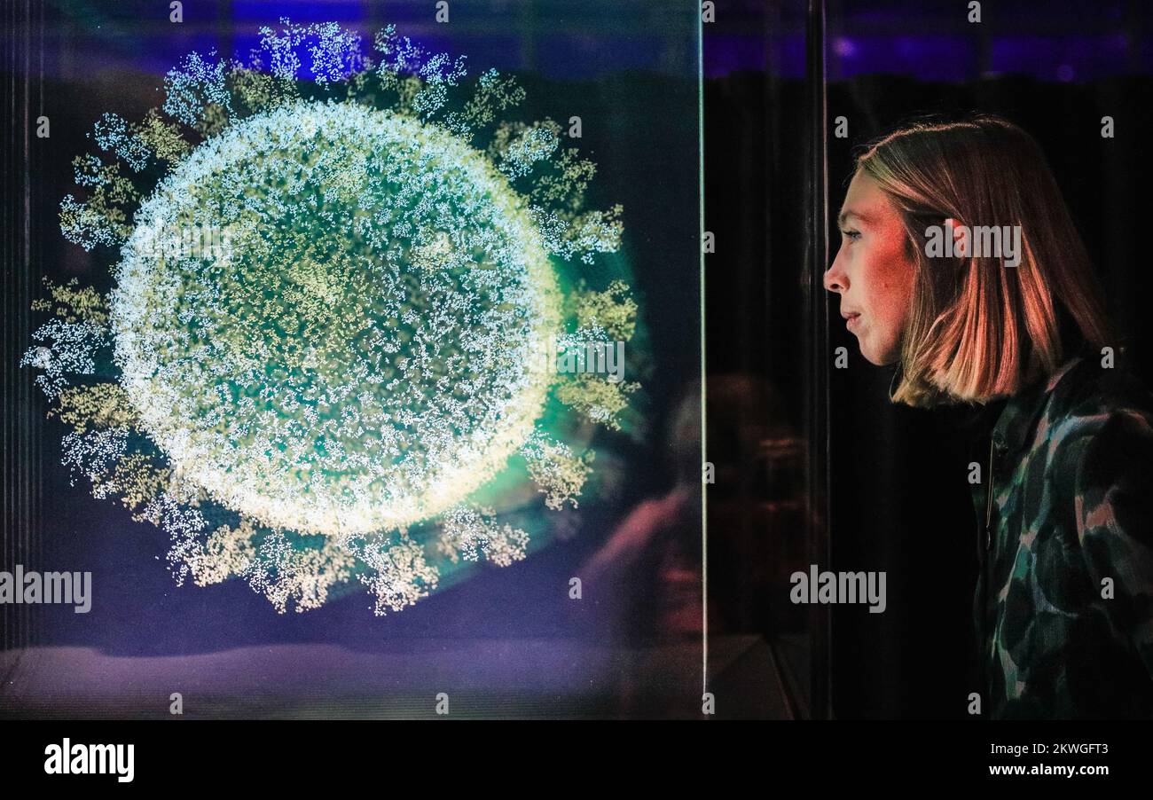 London, UK. 30th Nov, 2022. Museum staff pose with artist Angela Palmer ...