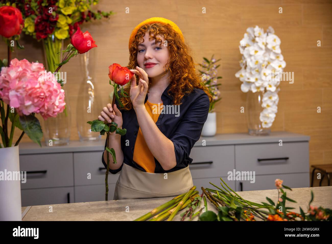 Young ginger girl in beret in a flower shop Stock Photo - Alamy