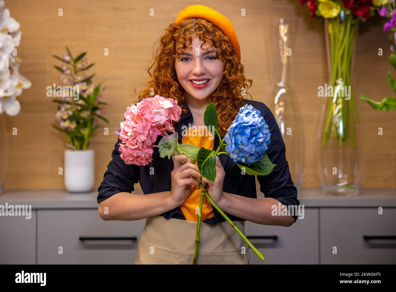 Young florist in a flower shop dealing with flowers Stock Photo - Alamy