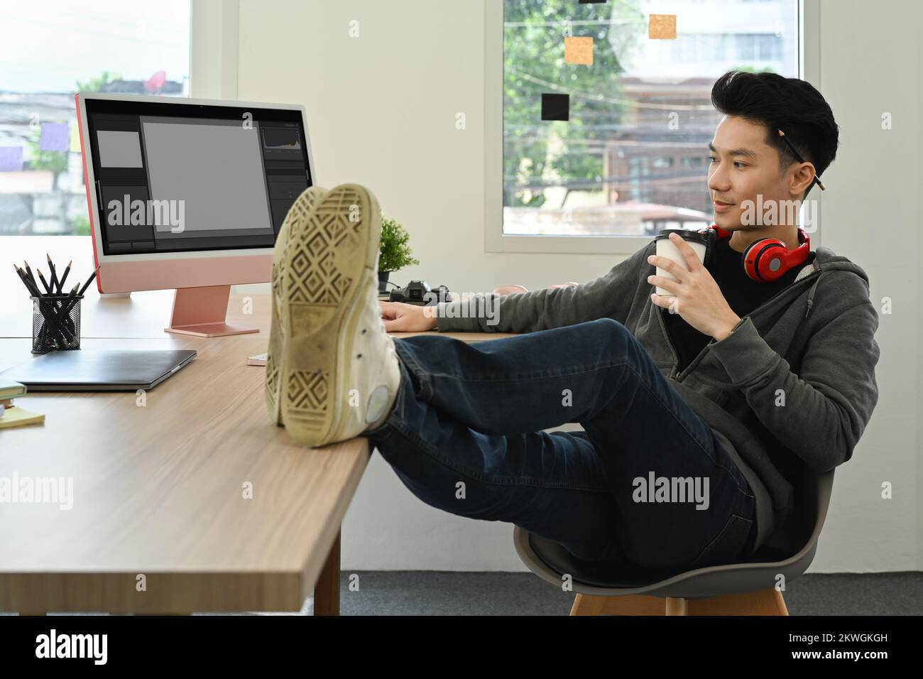 Young man video editor working with footage and post production montage ...