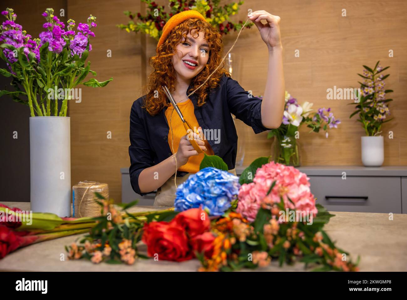 Young florist in a flower shop dealing with flowers Stock Photo - Alamy