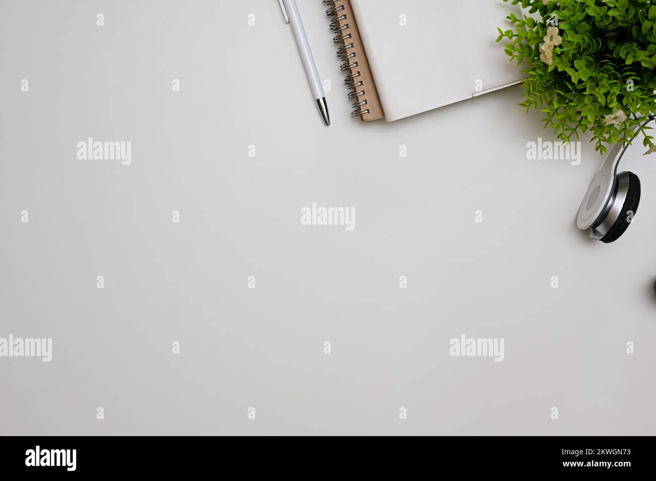 Simple white workspace with stationery, headphones and copy space for ...