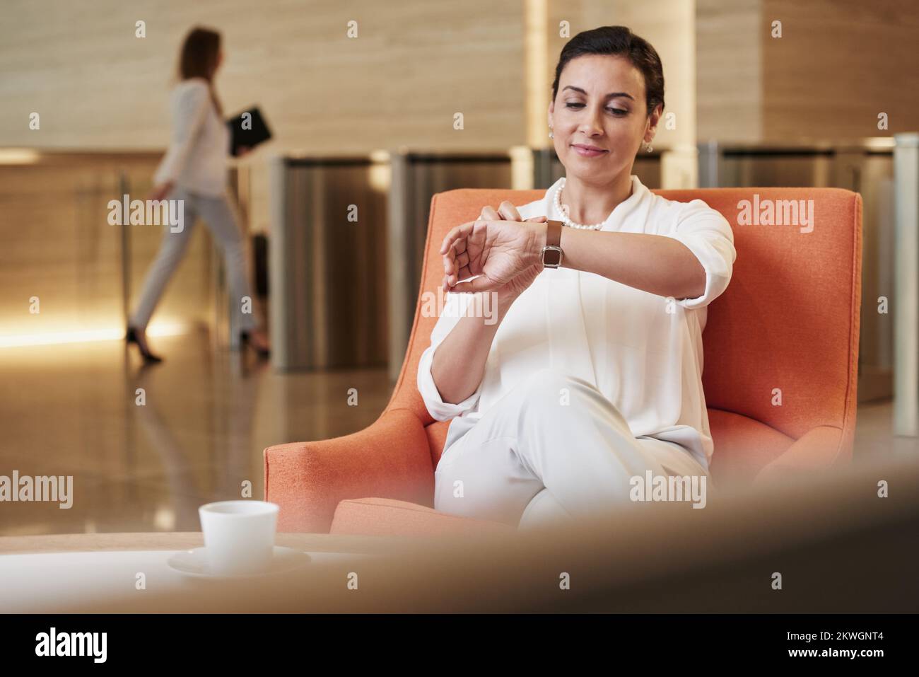 Airport, watch and time with a business woman waiting for her flight in ...