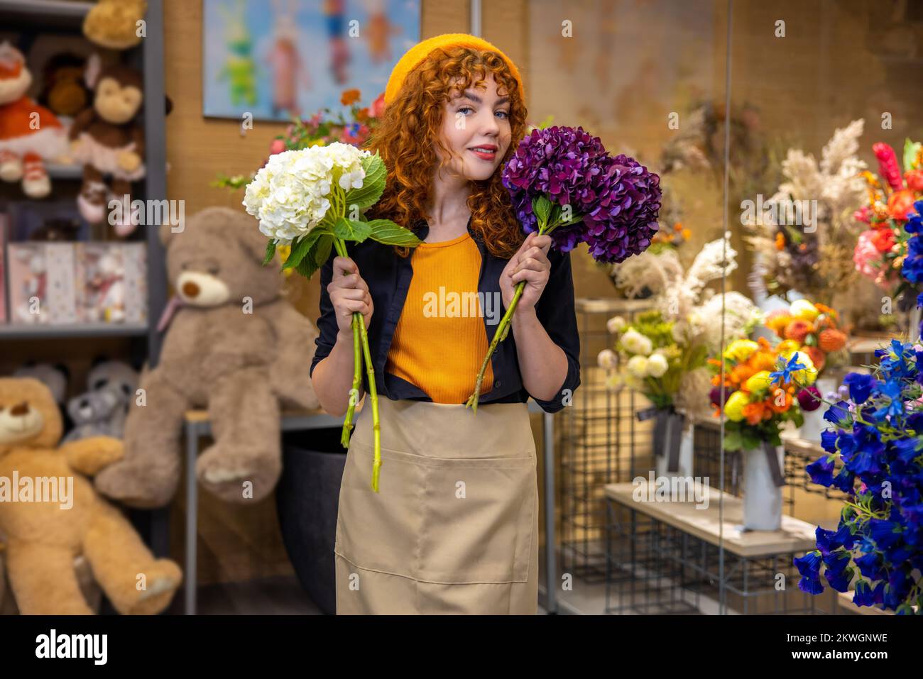 Cute smiling girl with flowers looking enjoyed Stock Photo - Alamy