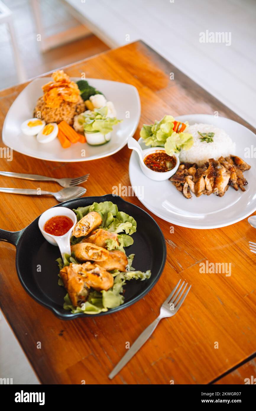 Beautiful thai food on a plate. Spring rolls with spicy sause, chicken ...
