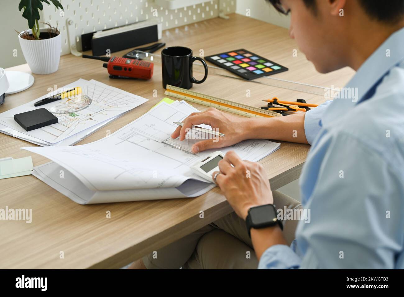 Cropped shot of architect man using calculator and working on ...
