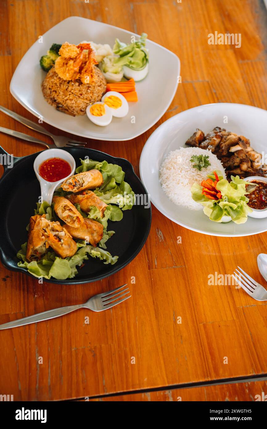 Beautiful thai food on a plate. Spring rolls with spicy sause, chicken ...