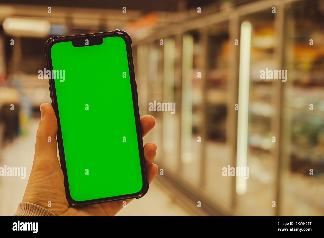 Mobile phone Chroma key on defocused frozen food fridge background ...