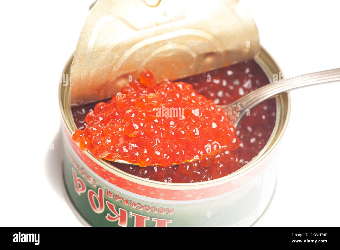 Metal can and spoon with delicious red caviar isolated on white ...