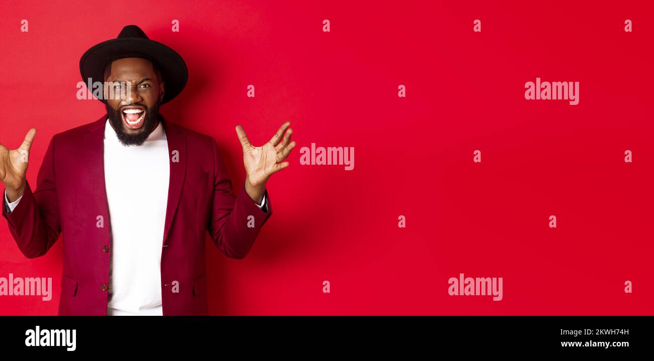 Angry Black man screaming and shaking hands with hatred, losing temper ...