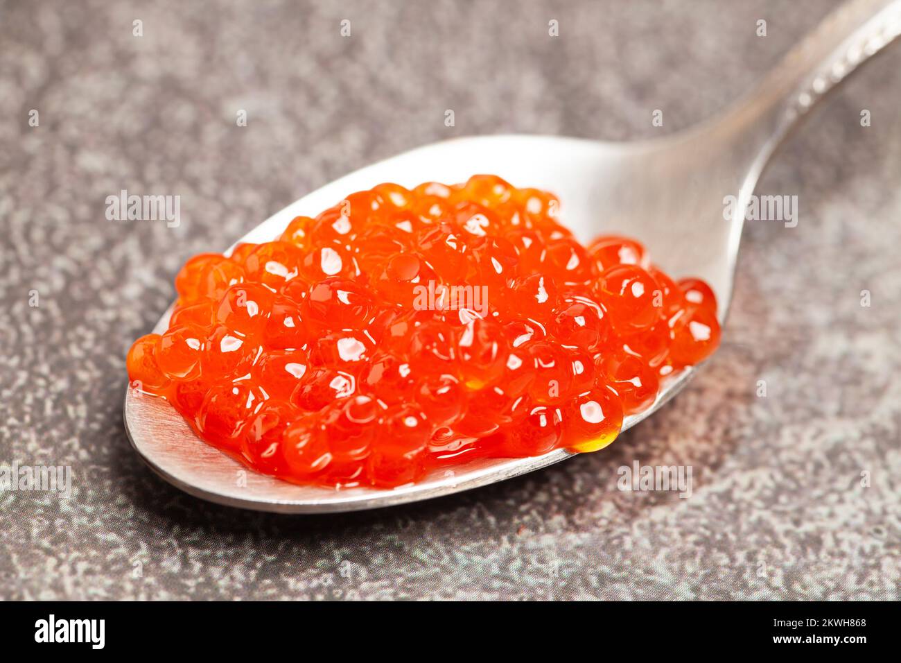 spoon with delicious red caviar on dark background Stock Photo - Alamy