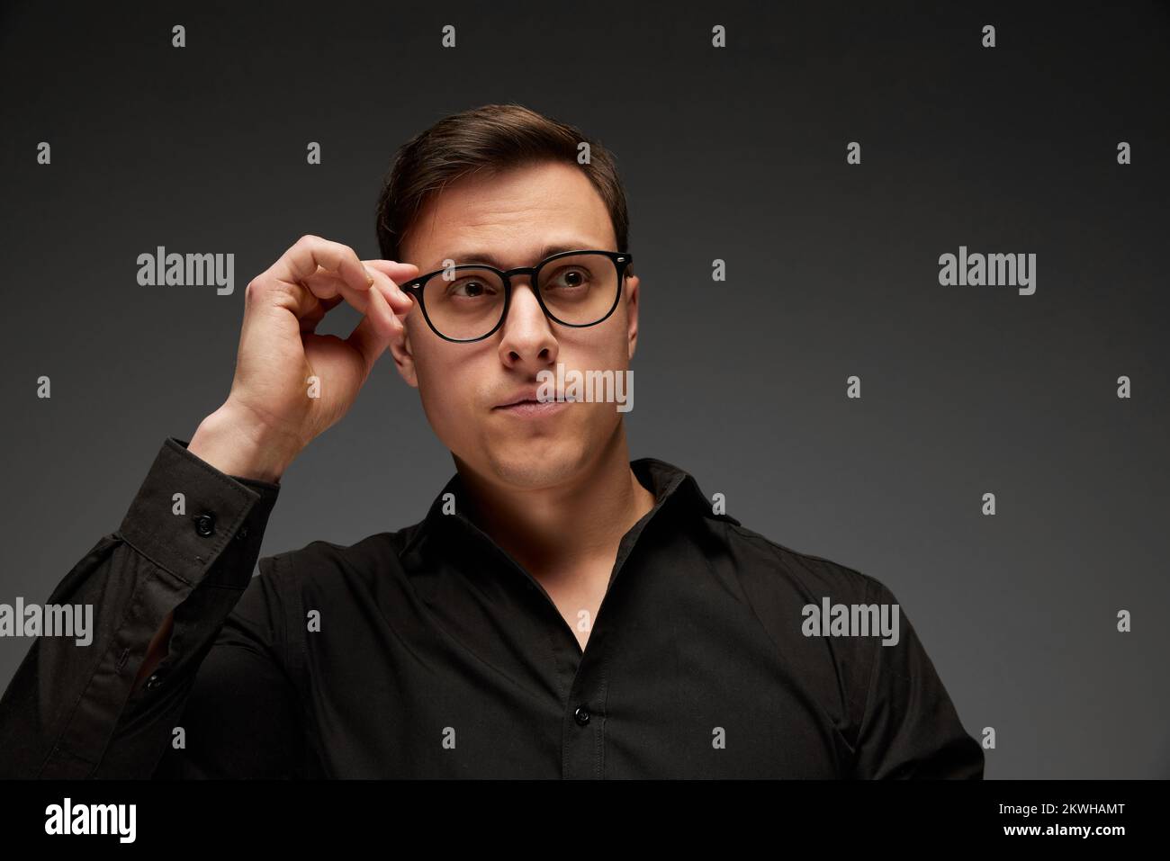Serious young man, manager in black business classic style shirt ...