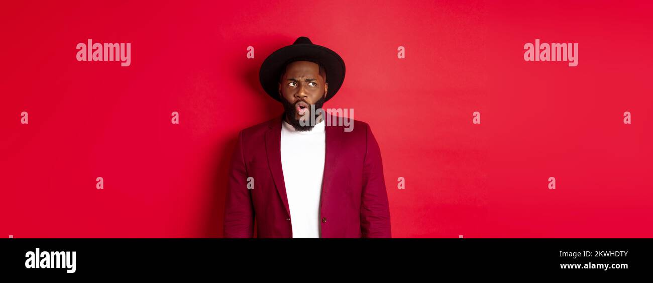 Fashion and party concept. Shocked and displeased black man staring at ...