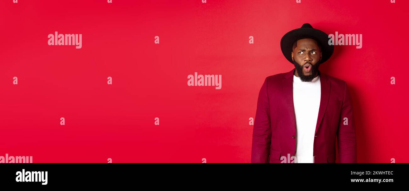 Fashion and party concept. Shocked and displeased black man staring at ...