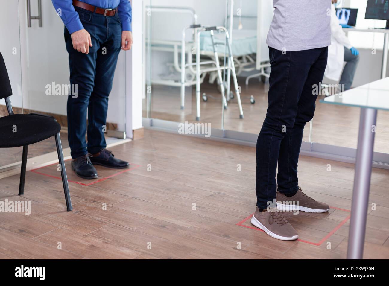 Mature man waiting in line in hospital corridor for coronavirus ...