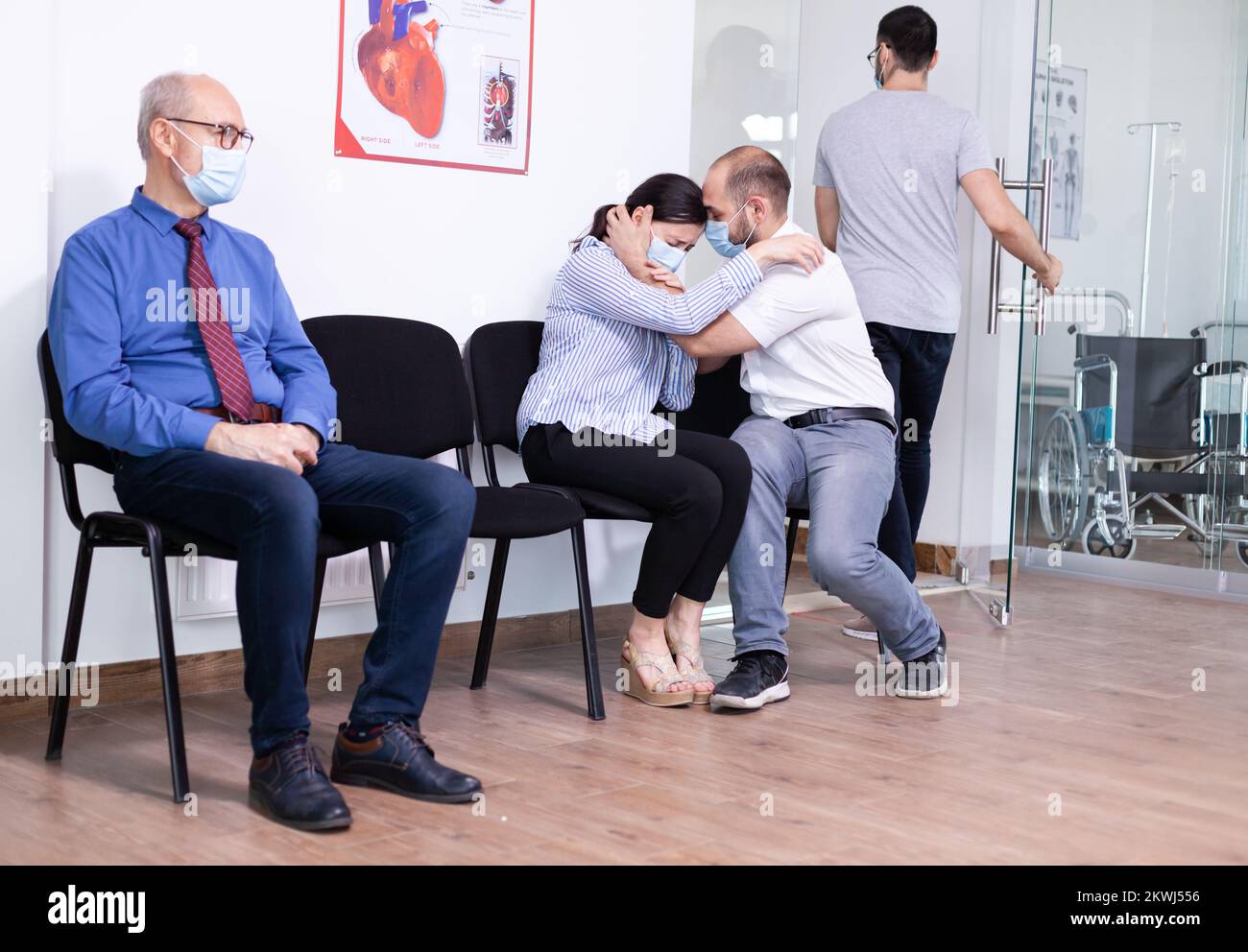 Worried young couple wearing face mask against infection with ...