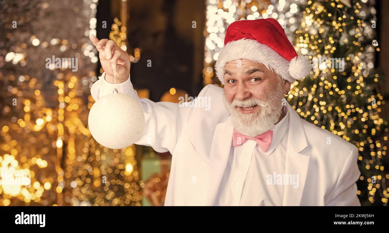 Christmas spirit. Kind grandpa with toy. Sparkling decorations ...