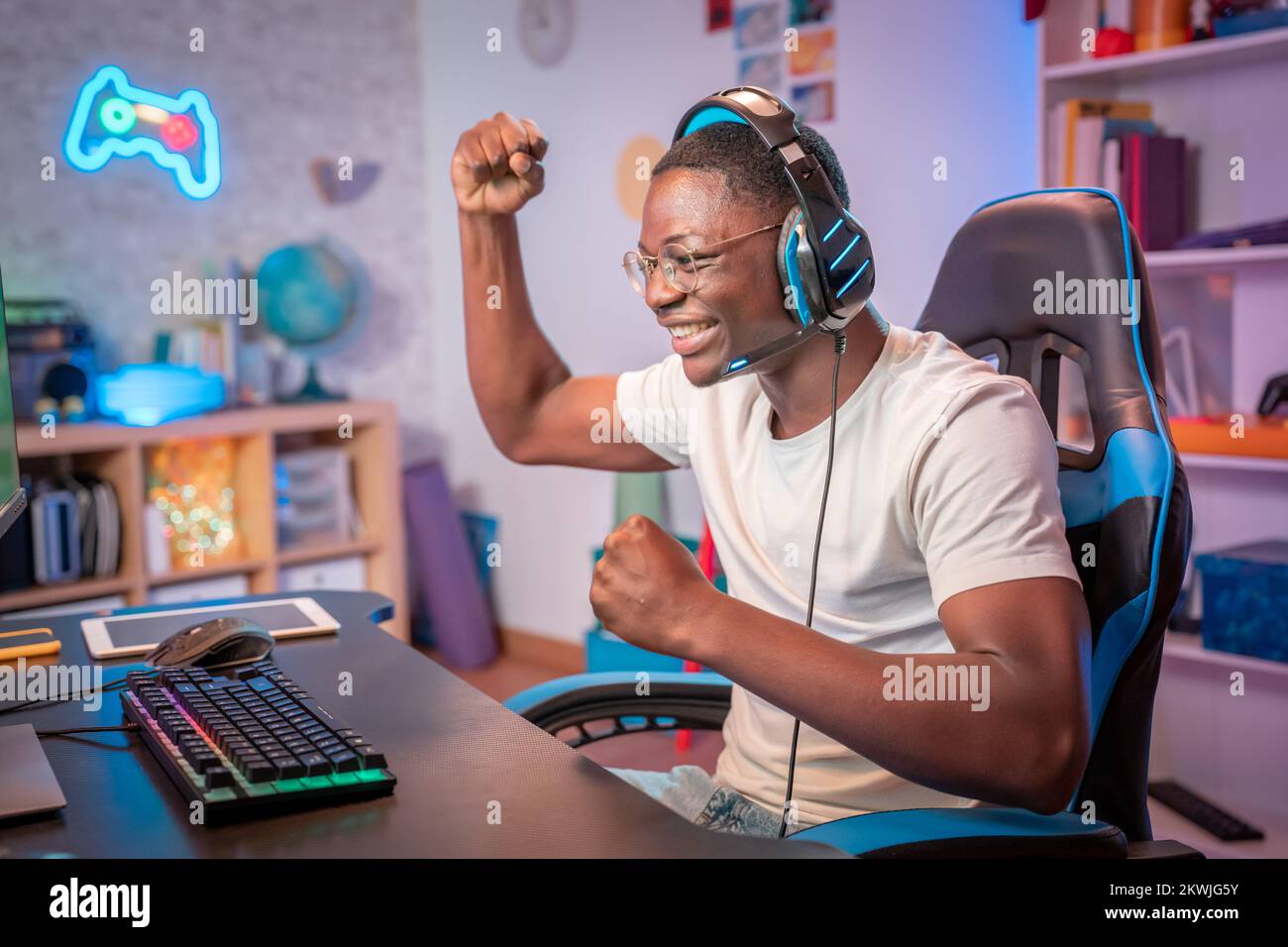 Young african american gamer happy winning the game celebrates victory ...