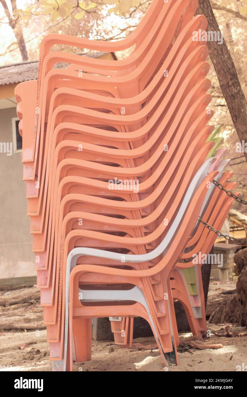 infrared image of the lots of stacked up plastic air chair at the park ...