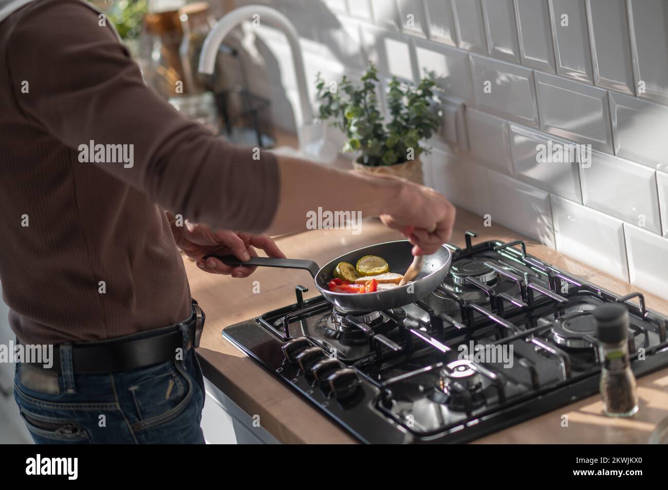 Man cooking something in the kitchen Stock Photo - Alamy