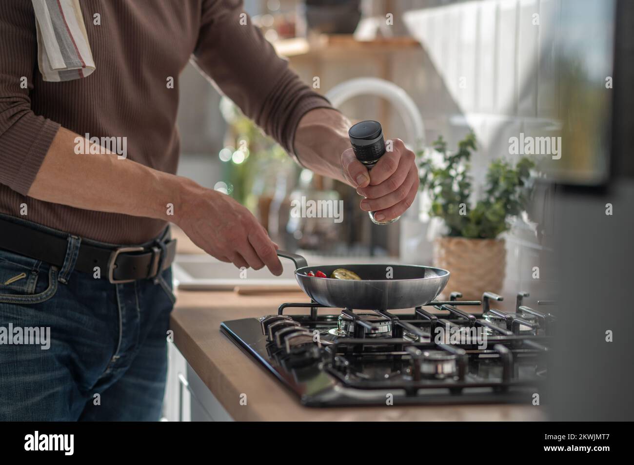 Man cooking something in the kitchen Stock Photo - Alamy
