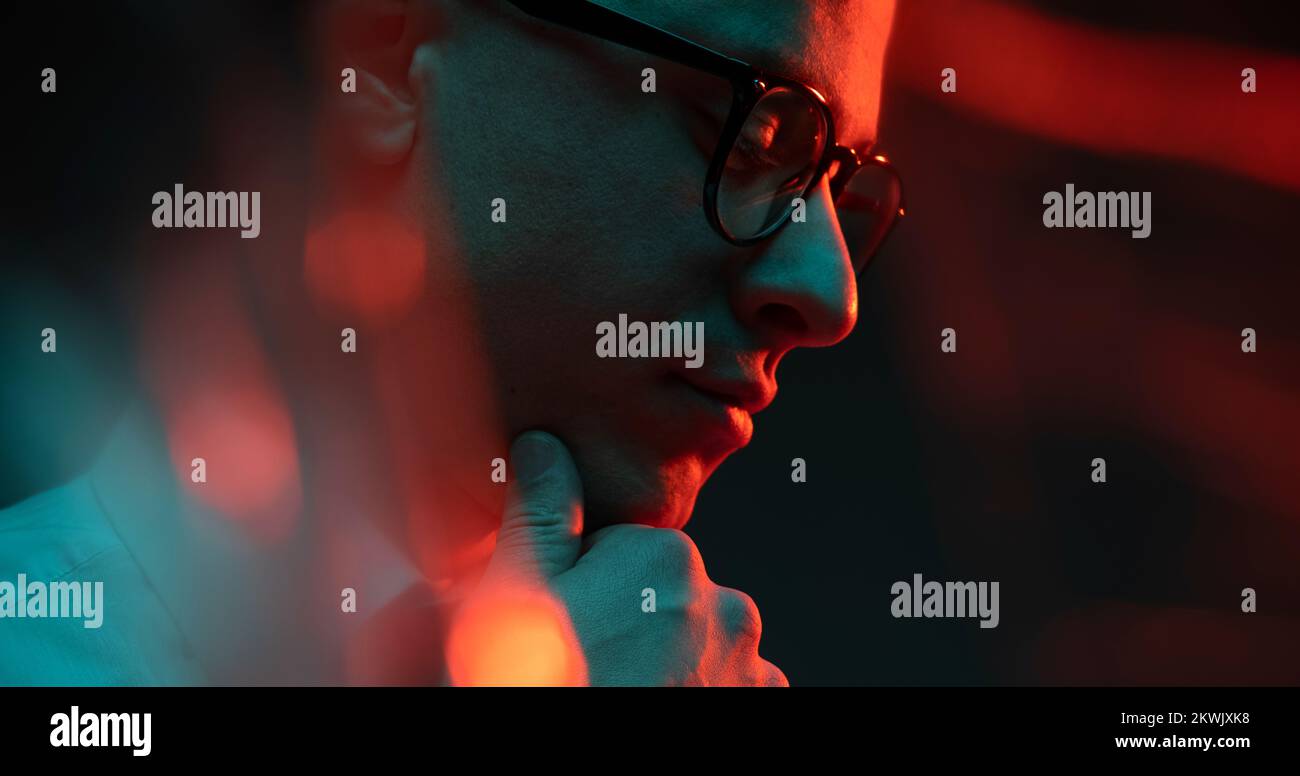Cinematic night closeup portrait of handsome man neon lights. Fashion ...