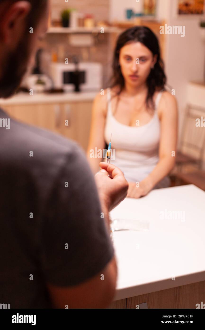 Victim of drug abuse using syringe with illegal substance in home ...